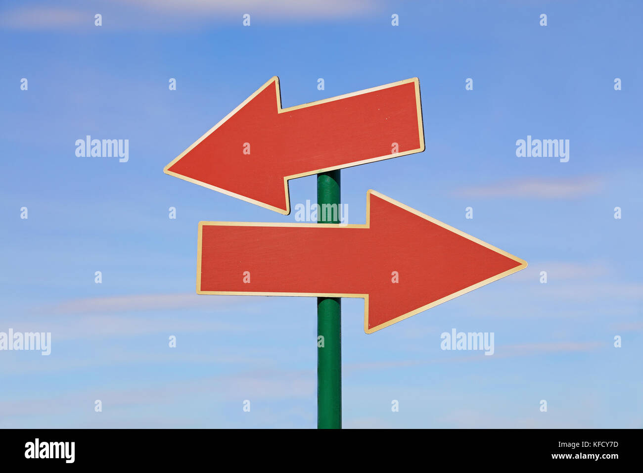 Road signpost with two red brown blank copy space arrows directing to ...