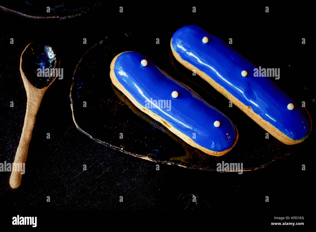 Blue eclairs with a mirrored glaze.A work of culinary art. Cakes Stock ...