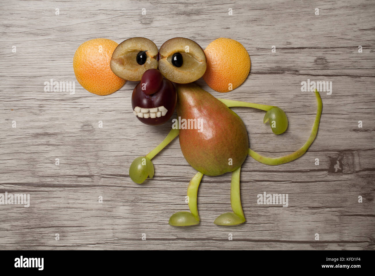 Ape made with fruits on wooden background Stock Photo - Alamy