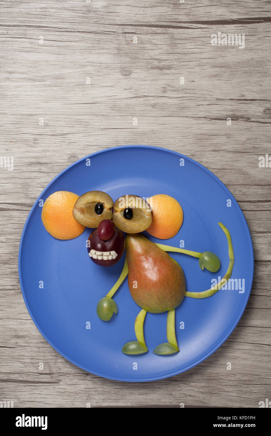 Monkey made with fruits on wooden background Stock Photo - Alamy