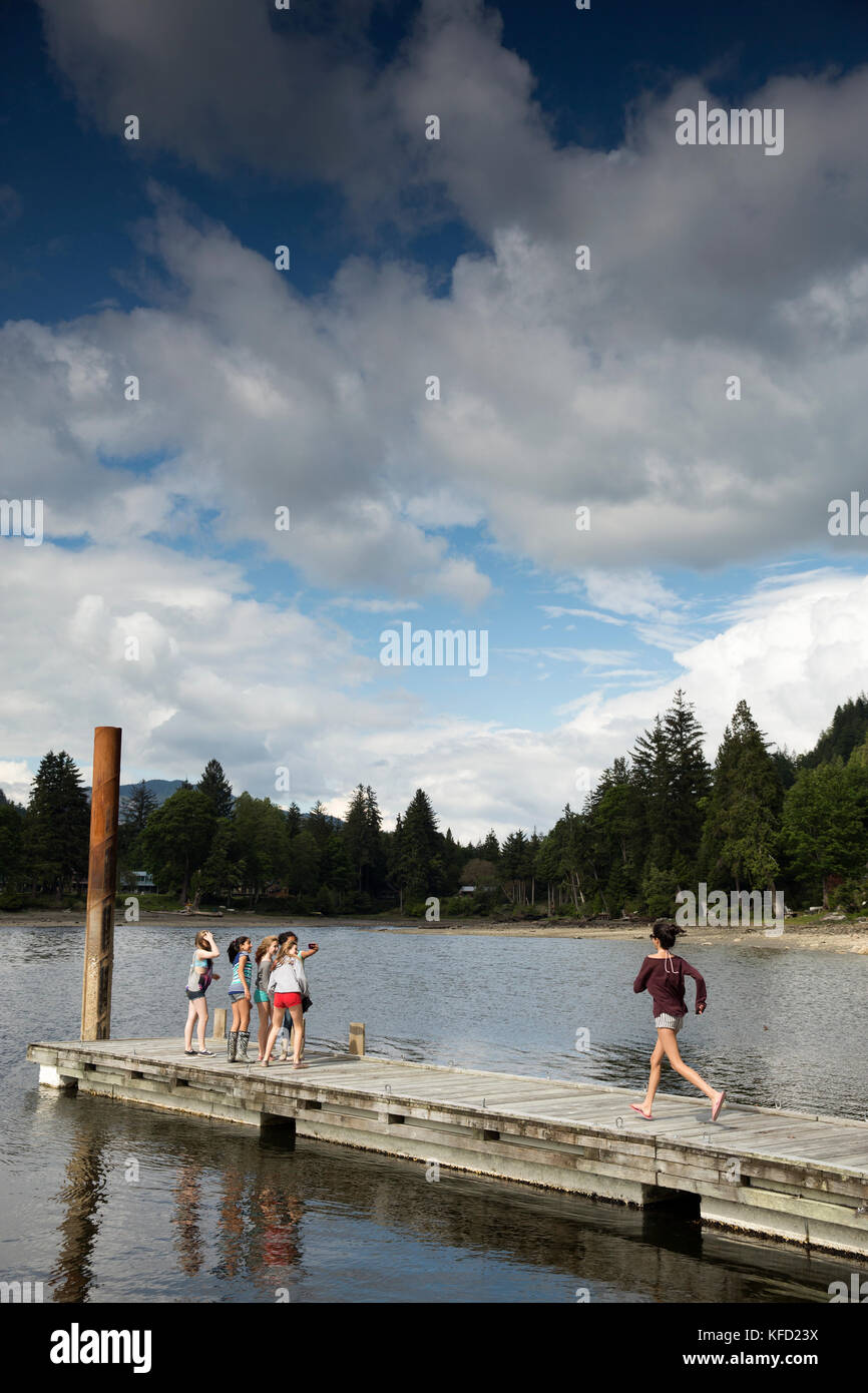 CANADA, Vancouver, British Columbia, young girls gather on the dock at ...