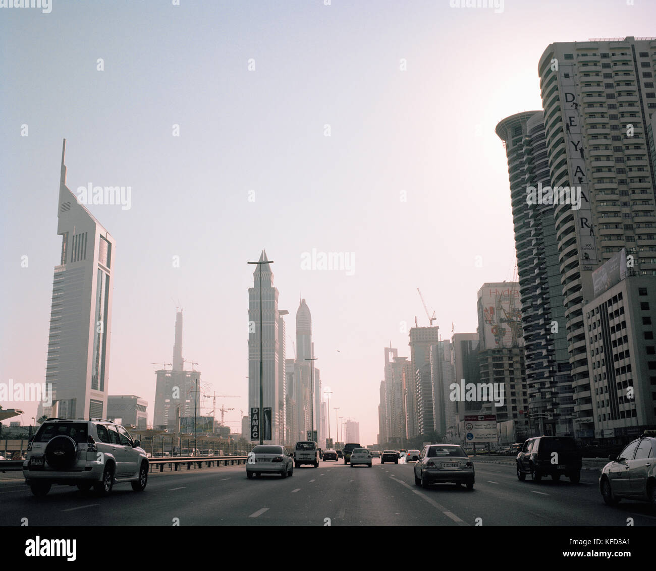 UNITED ARAB EMIRATES, Dubai, vehicles moving on street amid skyscrapers ...