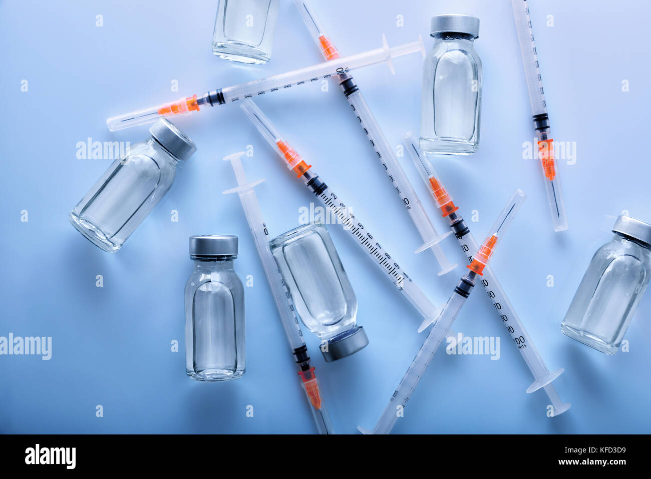 A lot of vials with medication and syringes on blue methacrylate table ...