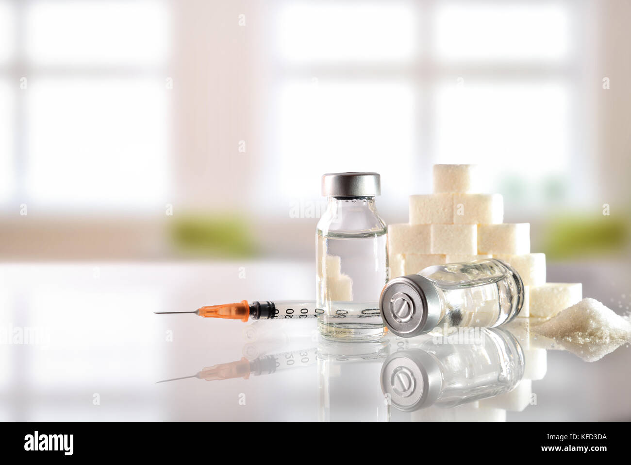 Insulin vials and syringe on white methacrylate table with window ...