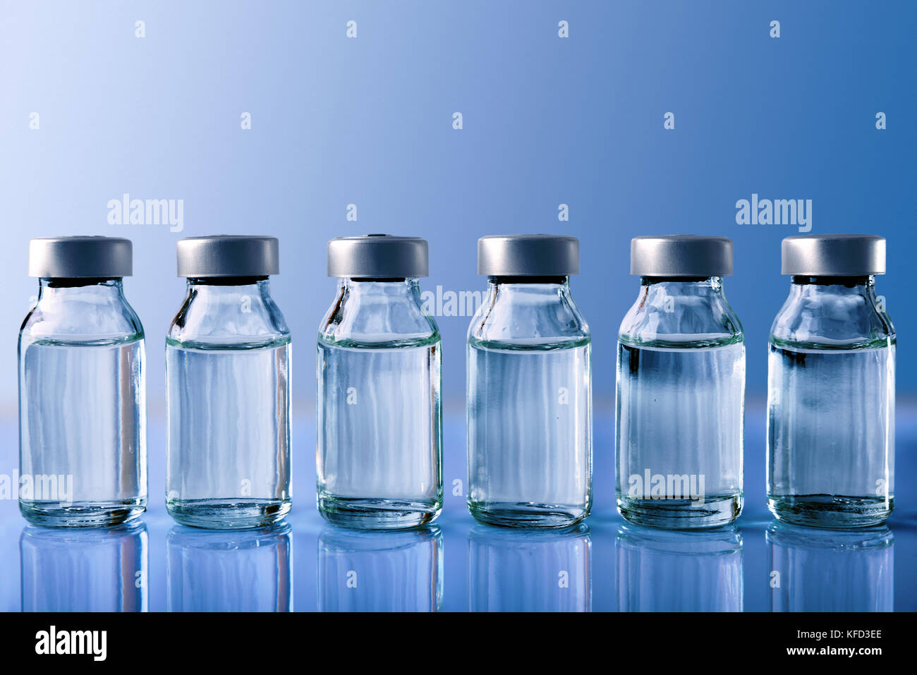 Row of vials with medication on blue methacrylate table. Horizontal ...