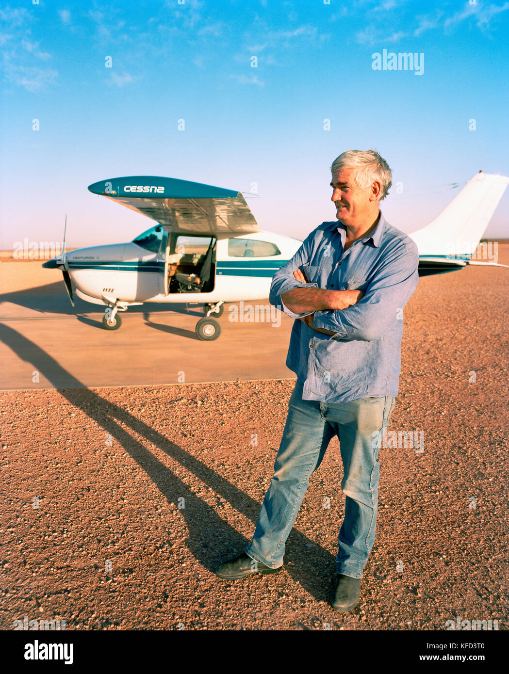 AUSTRALIA, the Outback, Pilot Trevor Wright standing next to his ...