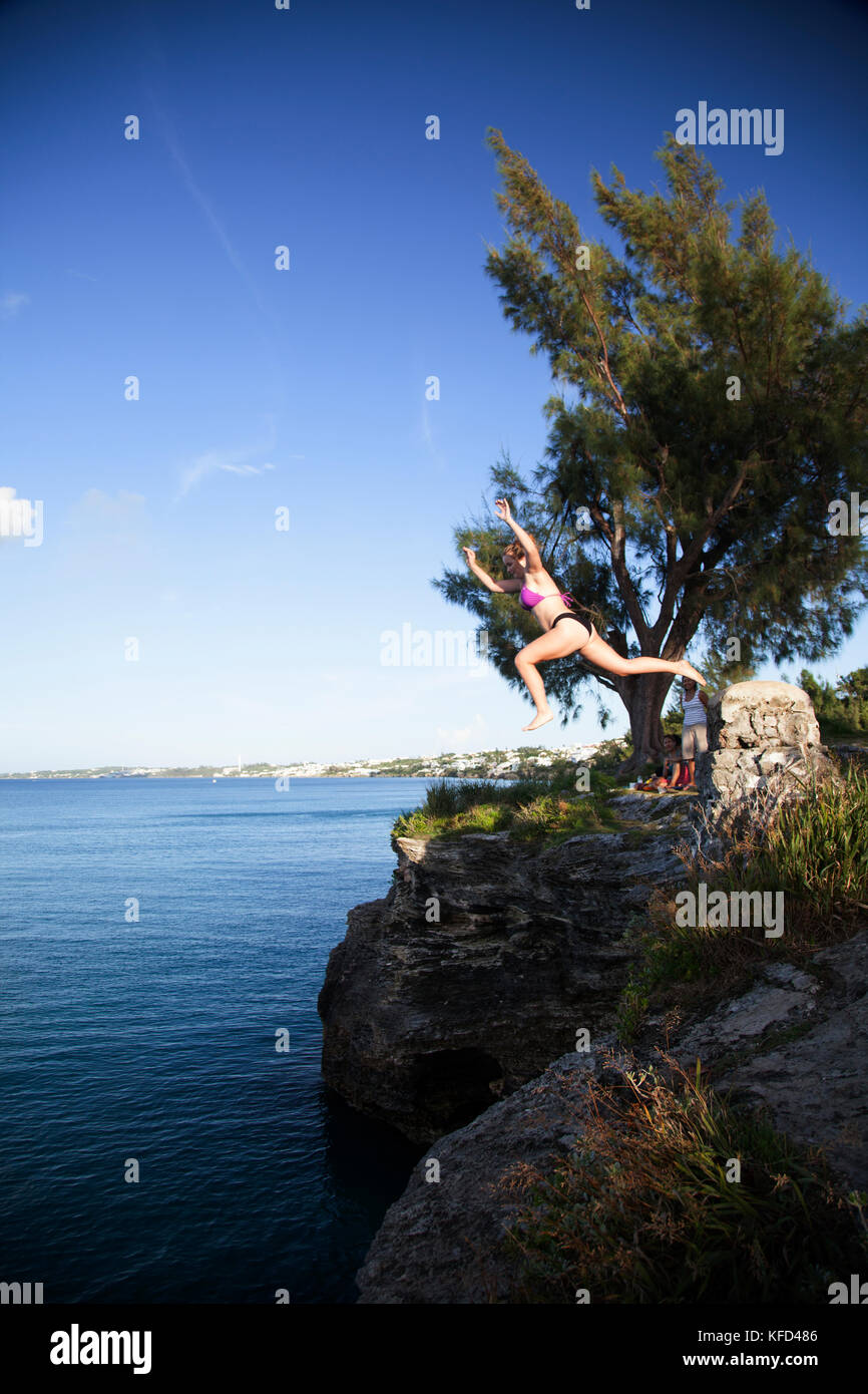 BERMUDA. Hamilton Parish. Cliff jumping, swimming off a point in ...