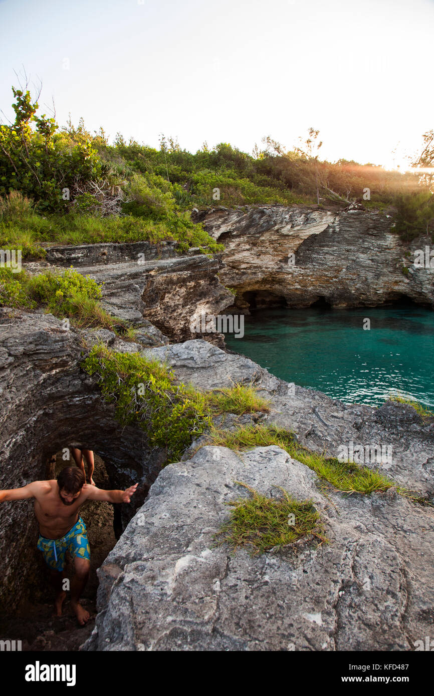 BERMUDA. Hamilton Parish. Cliff jumping, swimming off a point in ...