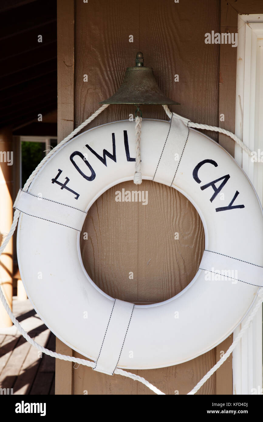 EXUMAS, Bahamas. Fowl Cay sign and bell at the office of the Fowl Cay ...