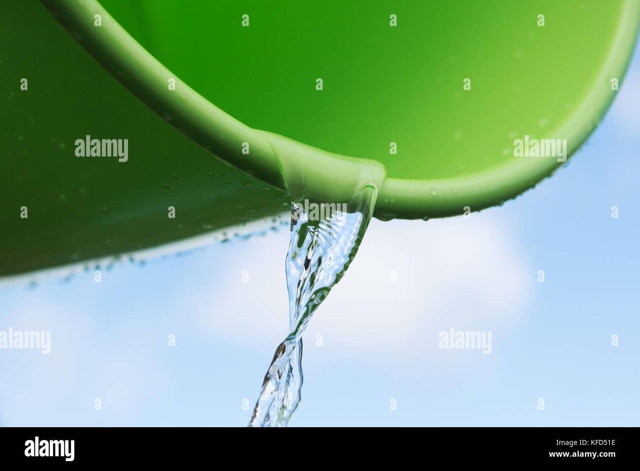Green bucket and pouring water Stock Photo - Alamy