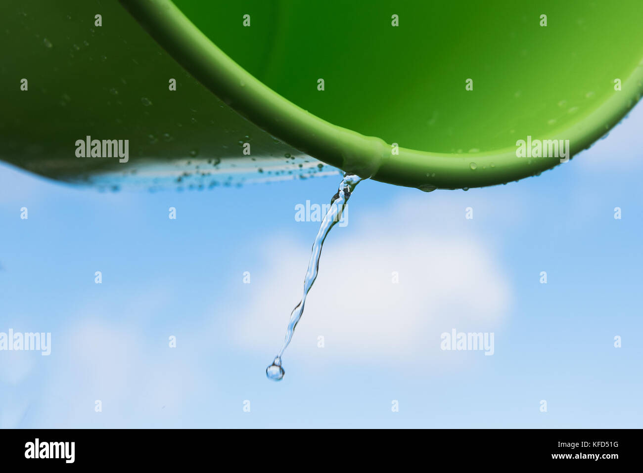 Green bucket and pouring water Stock Photo - Alamy