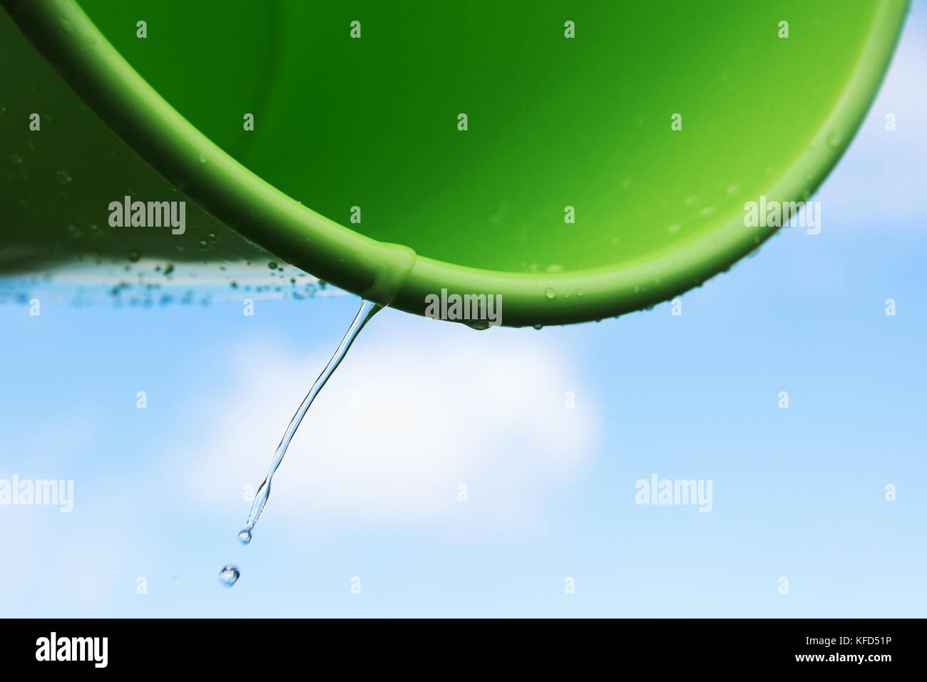 Green bucket and pouring water Stock Photo - Alamy