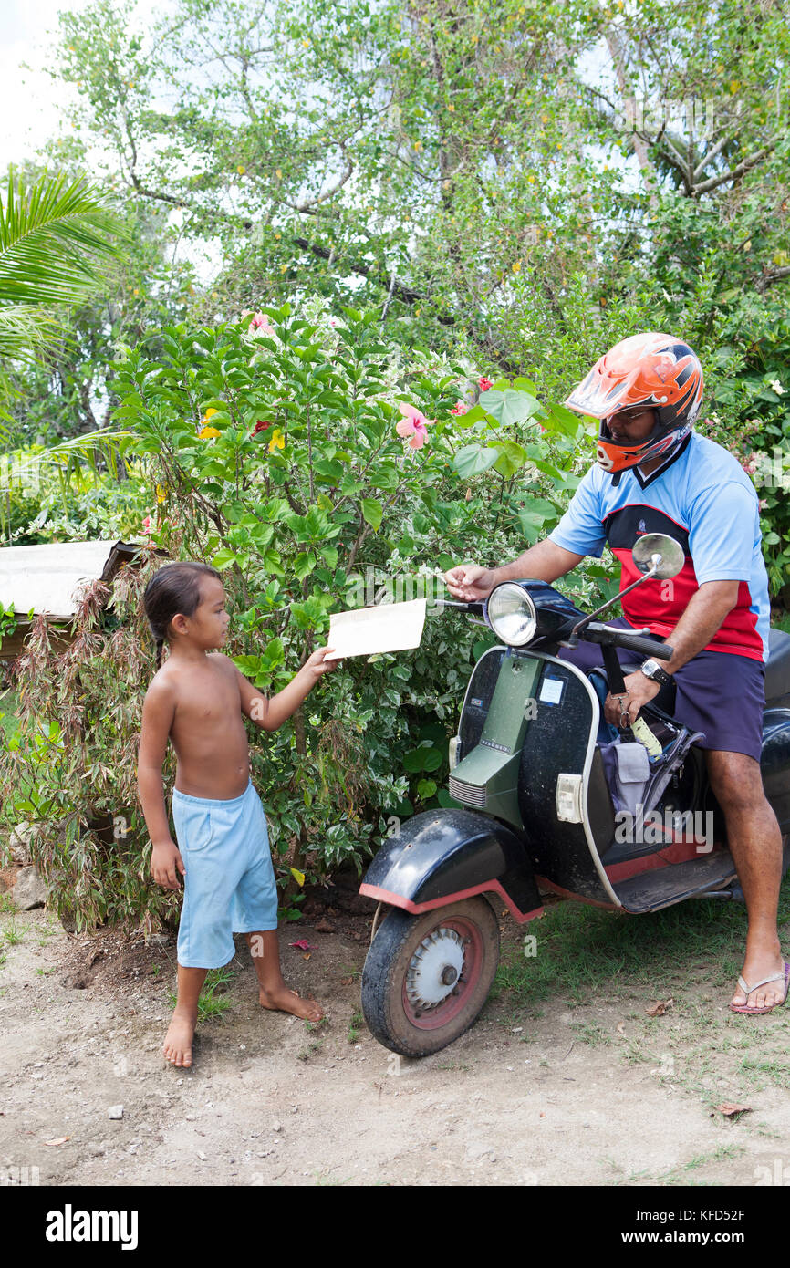 FRENCH POLYNESIA, Tahaa Island. The mailman delivering mail on Tahaa ...