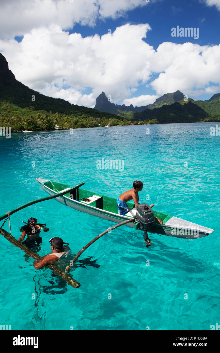 FRENCH POLYNESIA, Moorea Island. A family spearfishing at Opunohu Bay ...