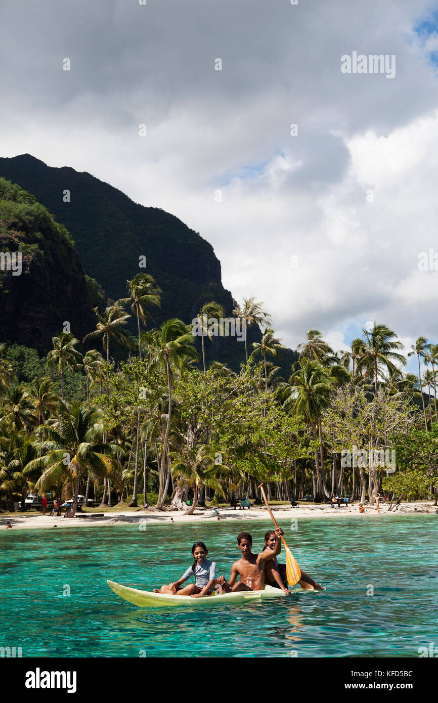 FRENCH POLYNESIA, Moorea. Young kids on canoe at Opunohu Bay Stock ...
