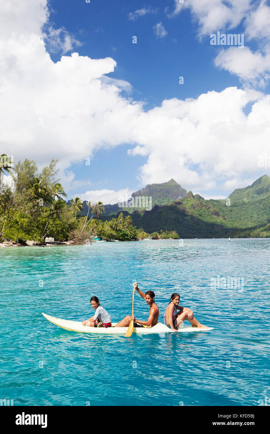 FRENCH POLYNESIA, Moorea. Young kids on canoe at Opunohu Bay Stock ...