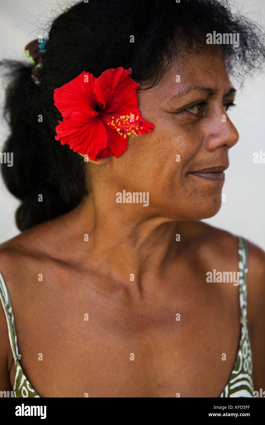 FRENCH POLYNESIA, Moorea. Portrait of woman with flower at the Te Nunoa ...