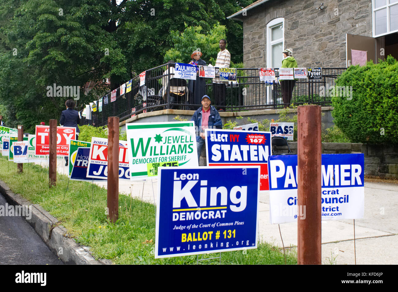 On Election Day numerous lawn signs are posted near the entrance of a ...