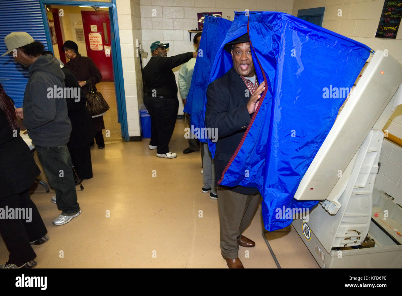 Voters emerge from behind the privacy curtain after casting the ballot ...
