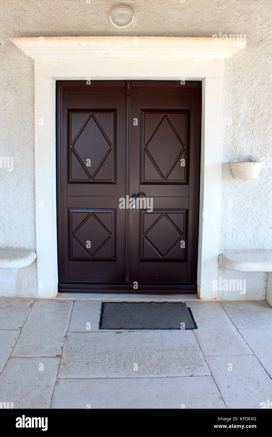Renovated chapel entrance with heavy new wooden doors inside massive ...