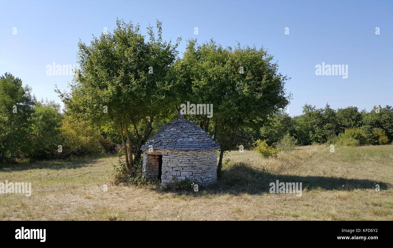 Traditional stone hut structure called Istrian Kazun surrounded with ...