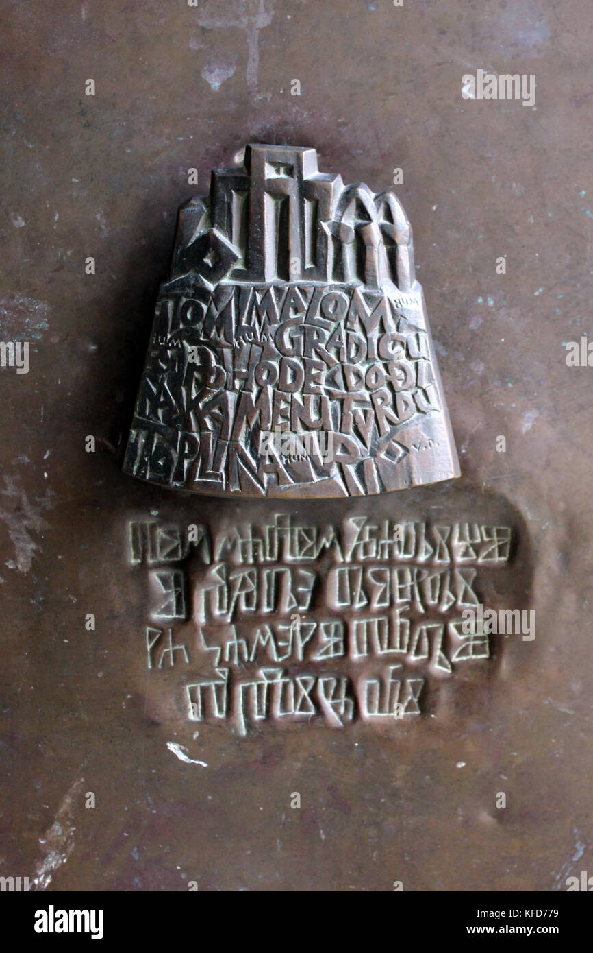 Glagolitic script carved in metal doors and handle on entrance to small ...