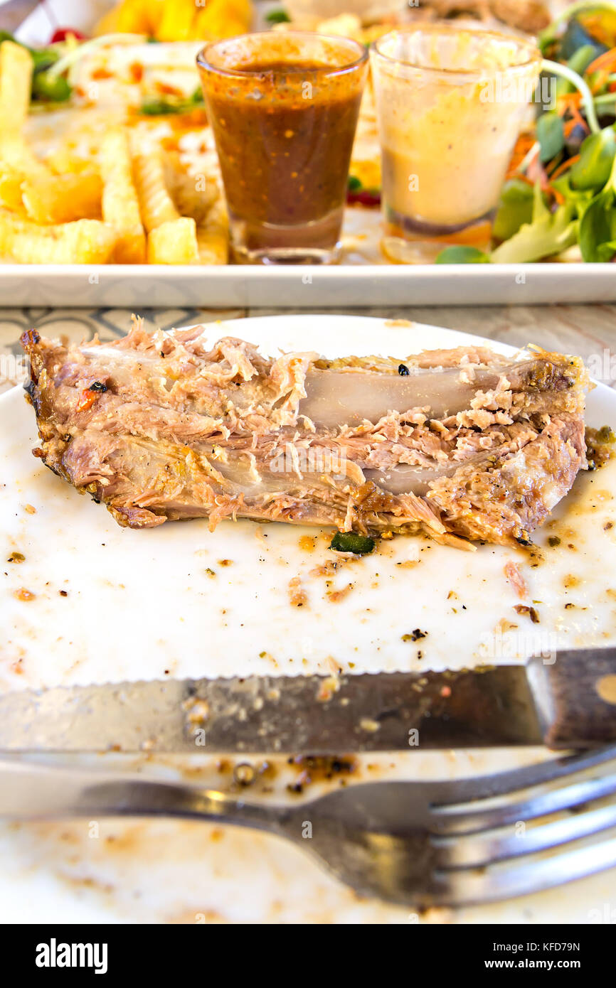 Dirty and empty steak dish with rib bone Stock Photo - Alamy