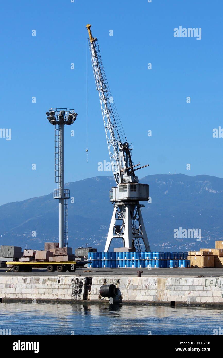 Old rusted shipyard loading crane located at the end of pier and still ...