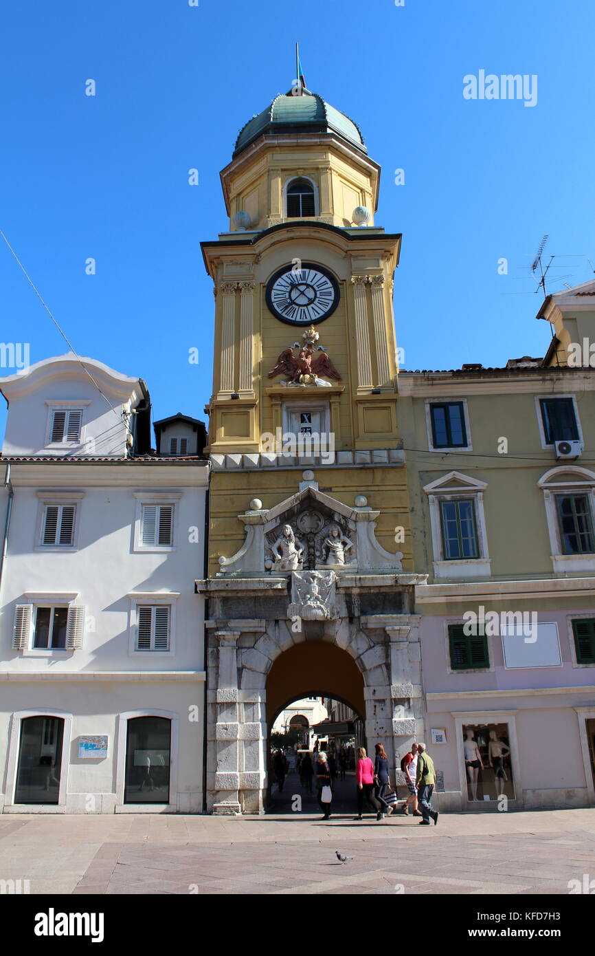 Antique clock tower building situated on main square with old building ...