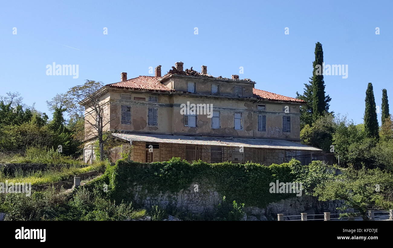 Old abandoned and partially demolished hotel building surrounded with ...