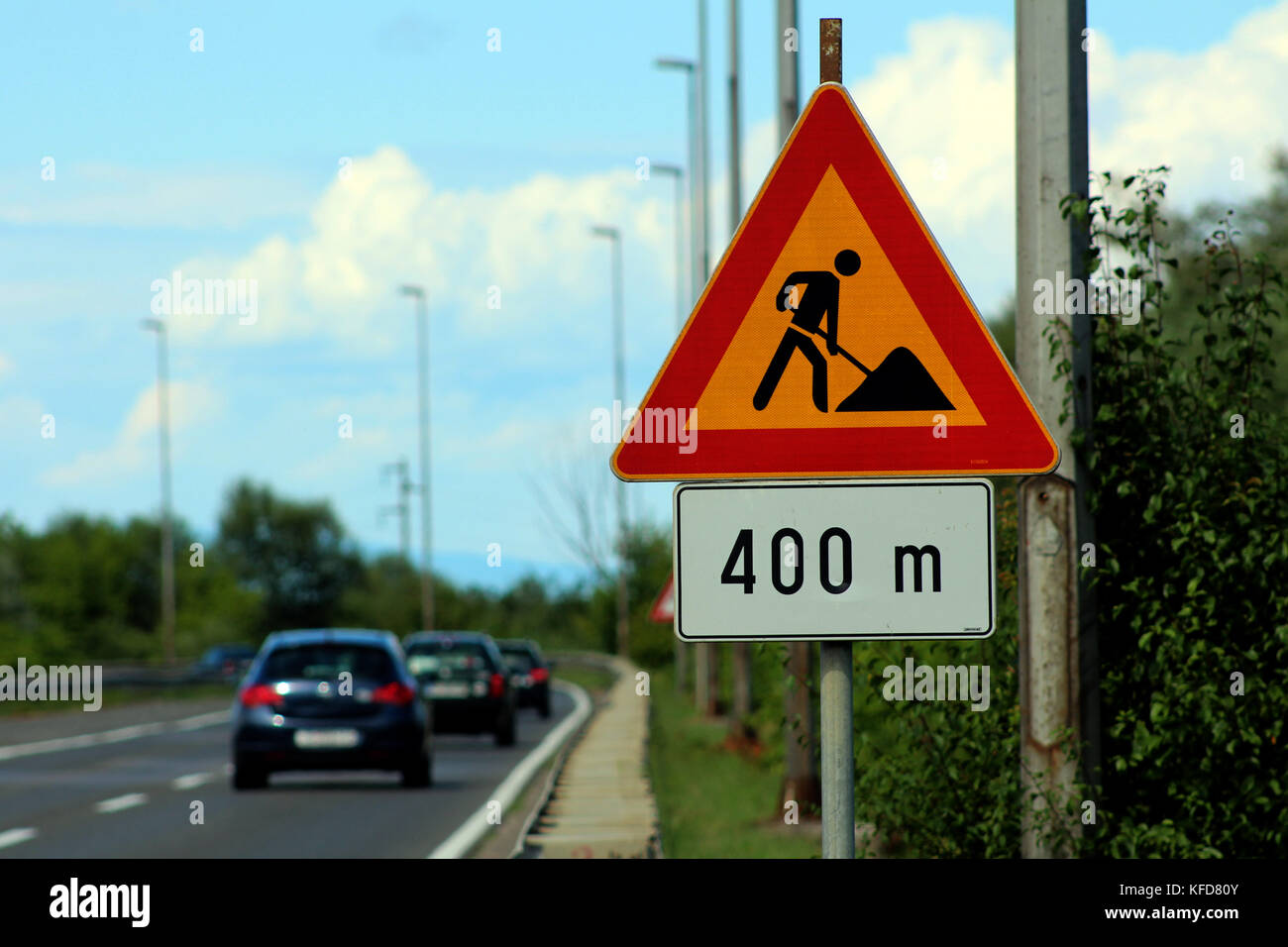 Road work ahead for 400 meters road sign near the road with multiple ...