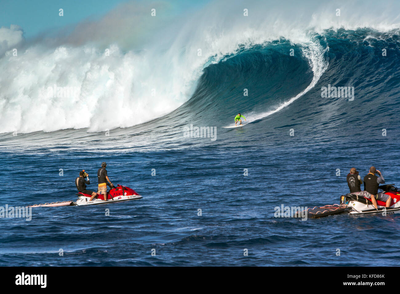 USA, HAWAII, Maui, Jaws, big wave surfers taking off on a wave at Peahi ...