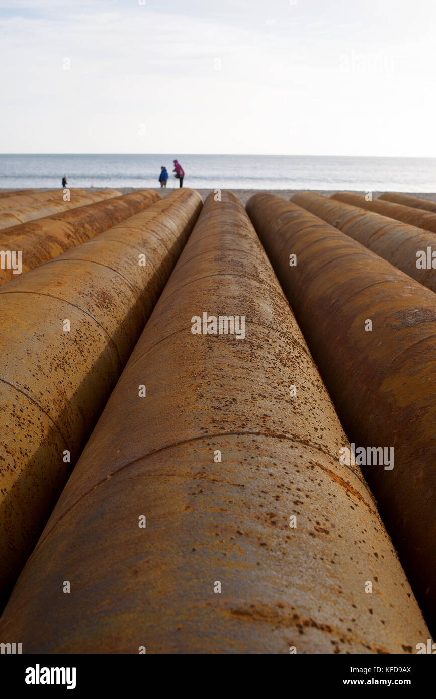 Large pipes on the beach during a civil engineering project Stock Photo ...