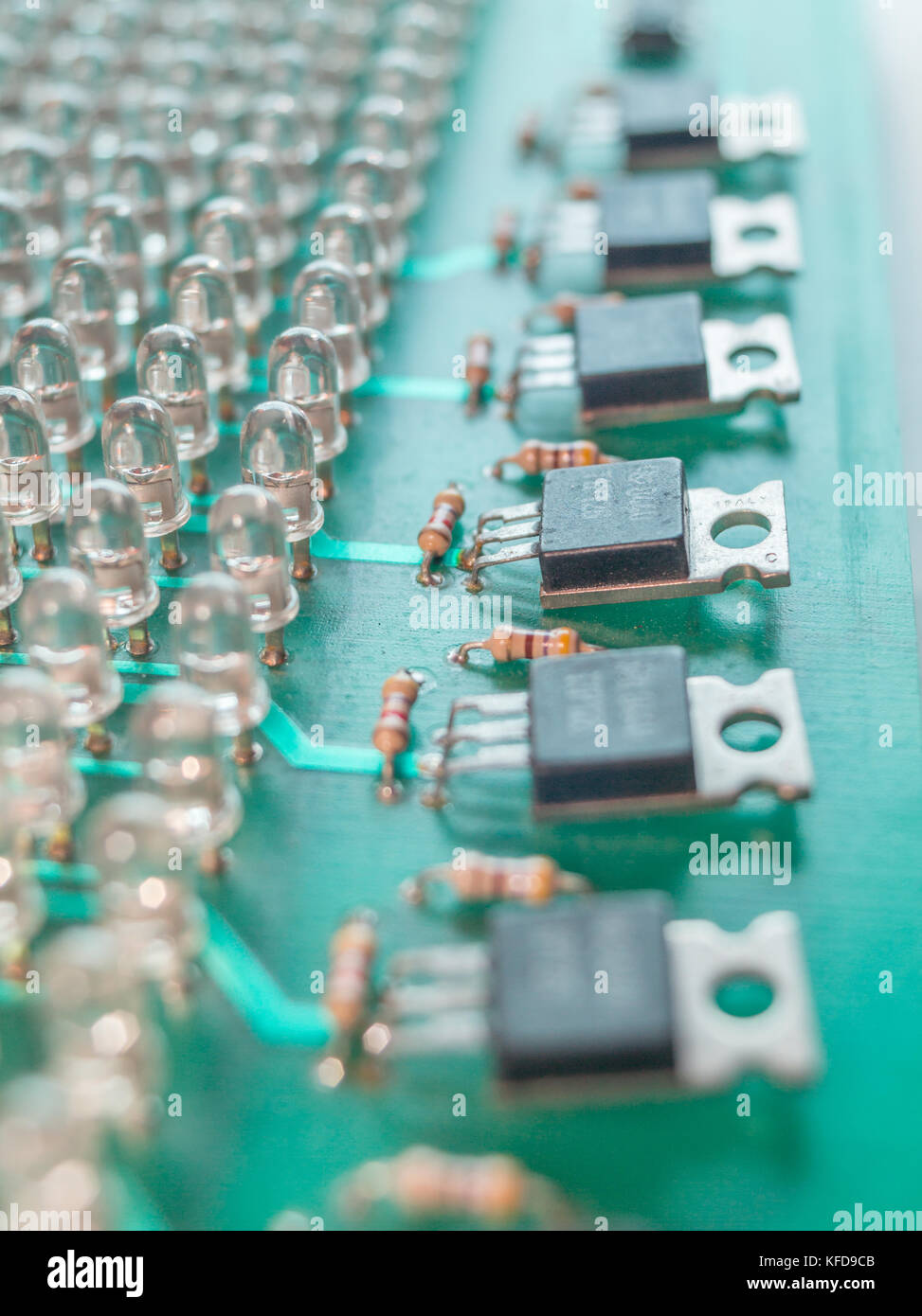 Green Circuit Board with many light diodes in row, and transistors ...