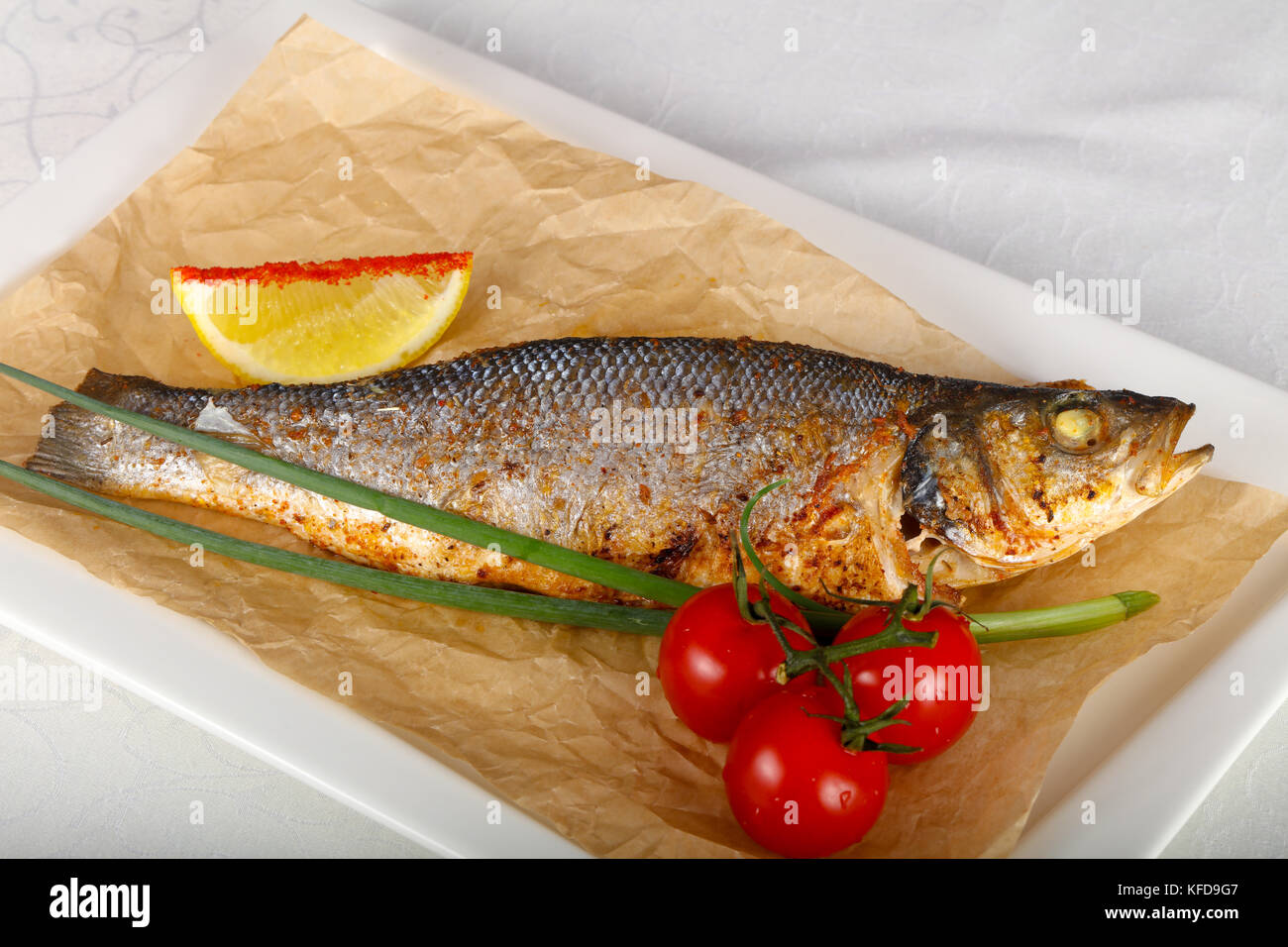 Seabass fish with lemon Stock Photo - Alamy