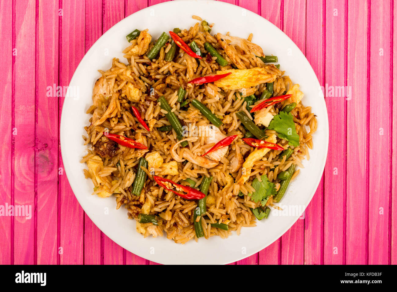 Indonesian Style Nasi Goreng Chicken and Rice Meal On A Pink Wooden ...
