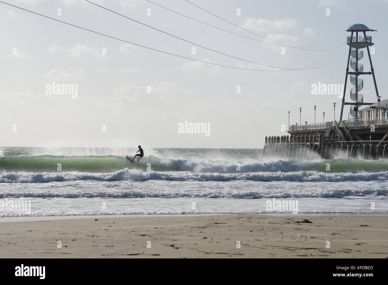 Surfer on the waves at Bournemouth Stock Photo - Alamy