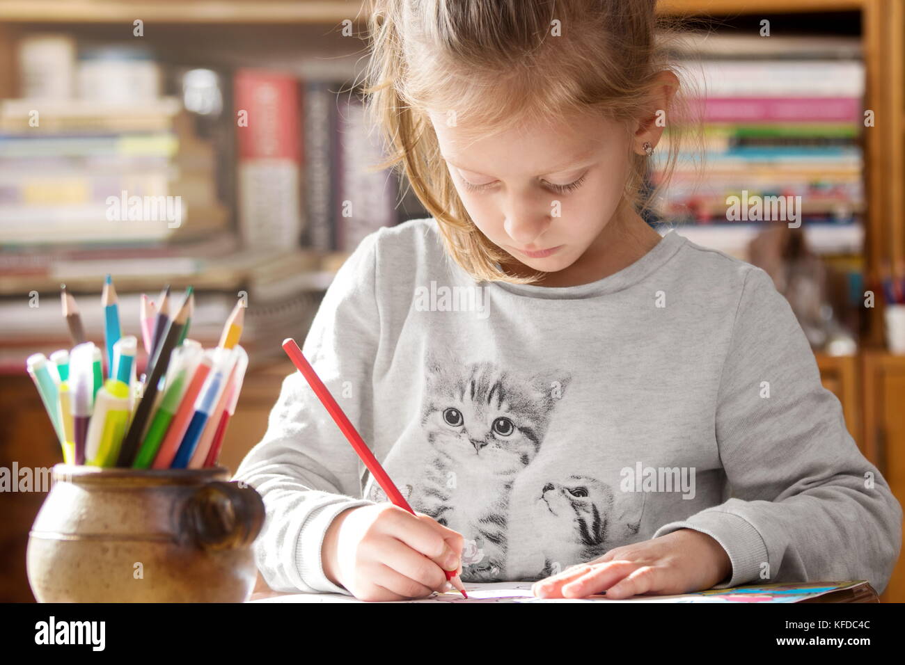 Girl coloring on paper having creative time at home Stock Photo - Alamy