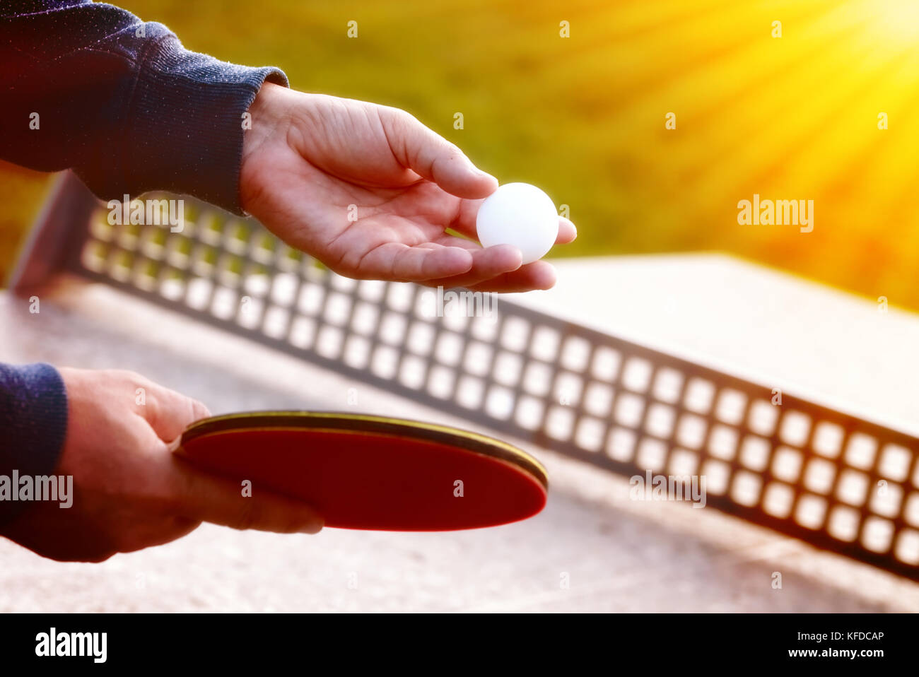 Close up of tennis player hands with tennis racket on nature background ...