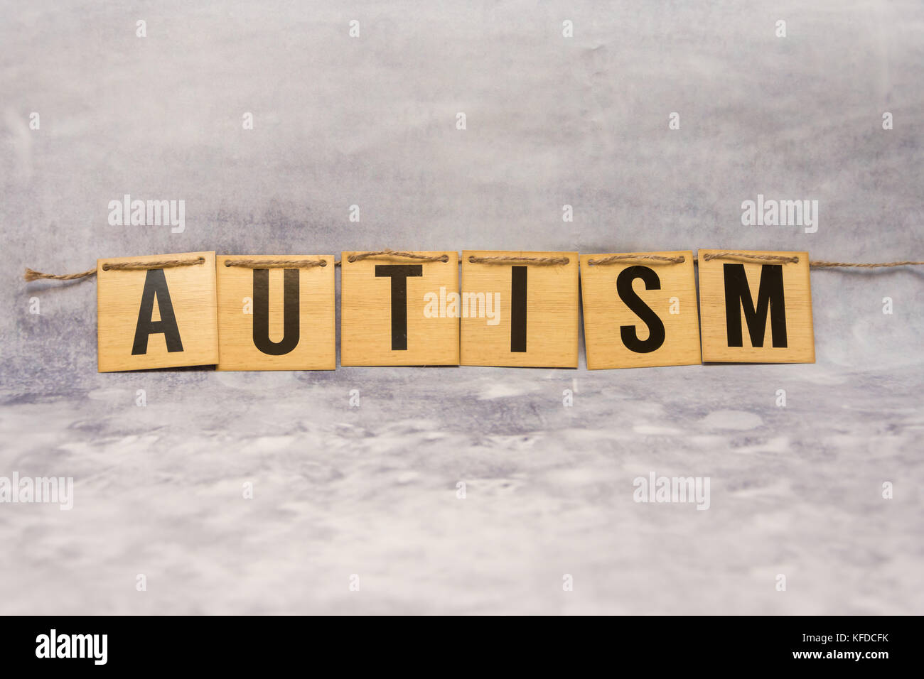 isolated tile letter of the alphabet on a patterned grey background ...
