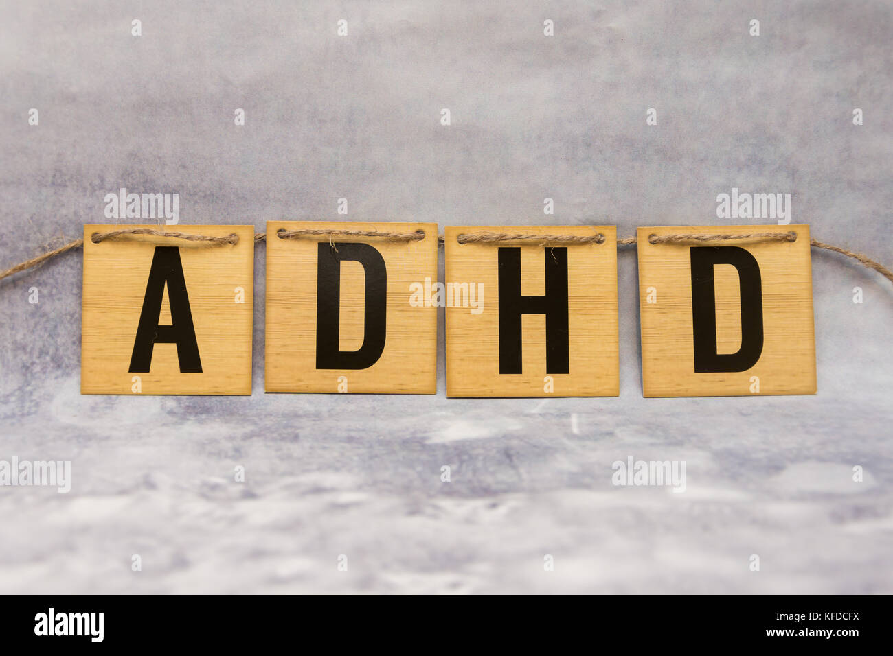 isolated tile letter of the alphabet on a patterned grey background ...