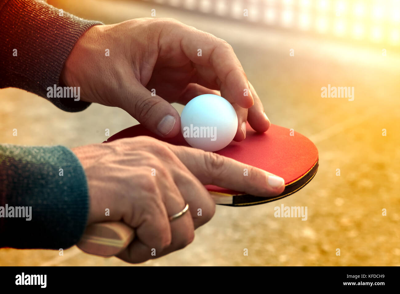 Close up of tennis player hands with tennis racket on nature background ...