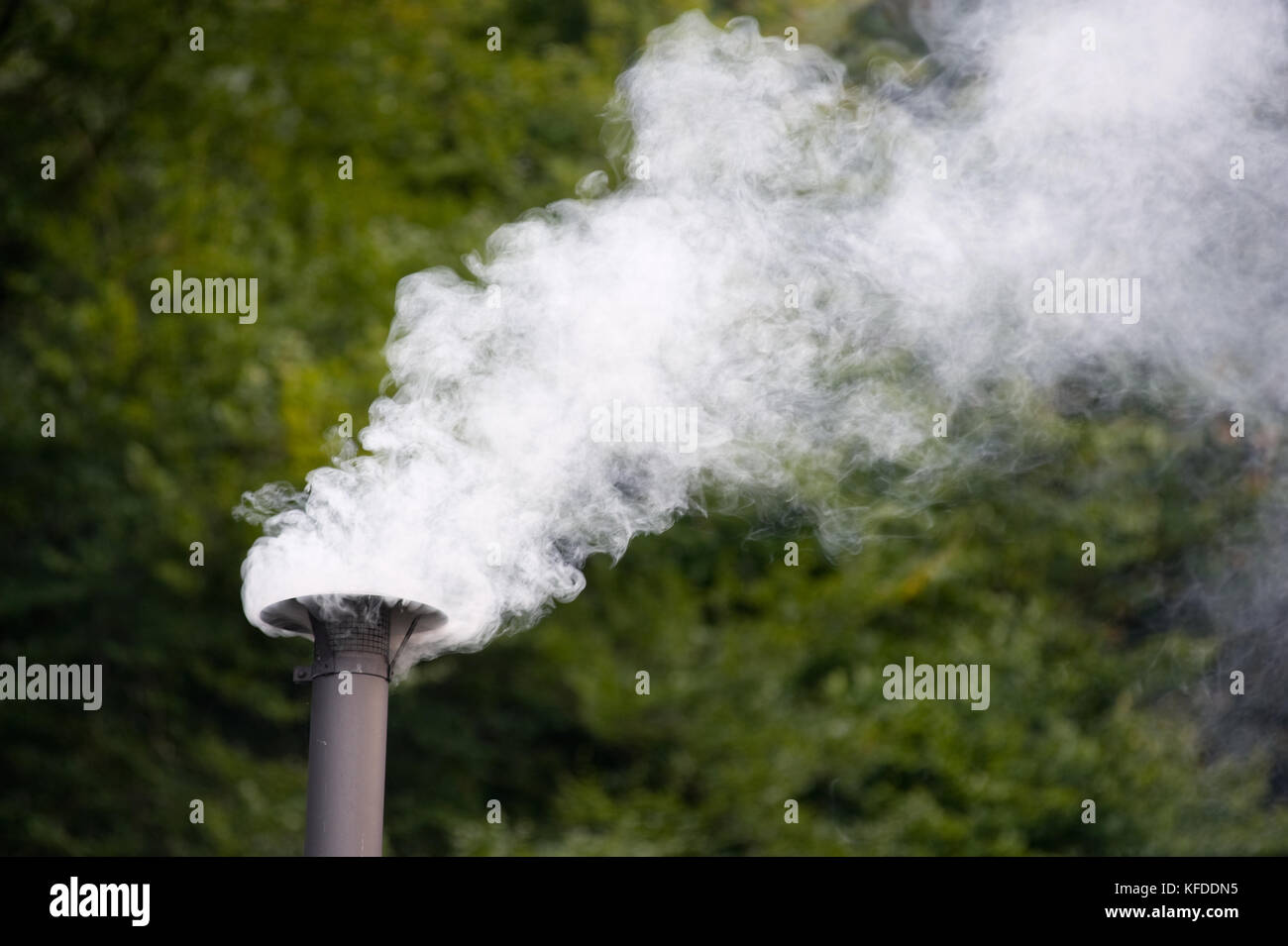 Smoke coming out of a small chimney Stock Photo - Alamy