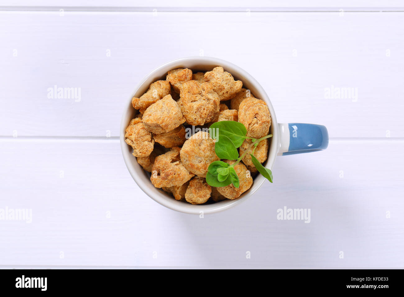 mug of soy meat cubes on white wooden background Stock Photo - Alamy