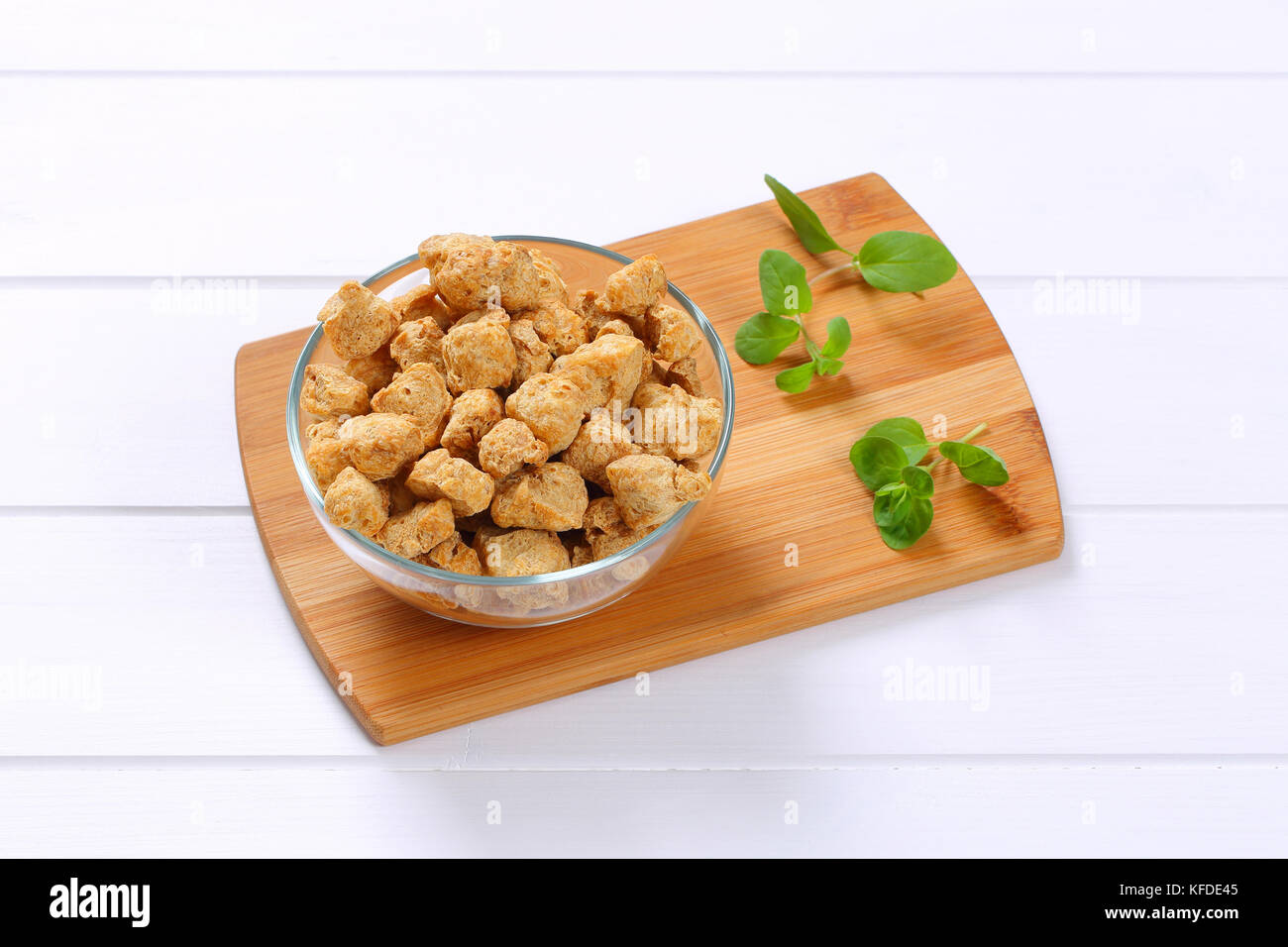 bowl of soy meat cubes on wooden cutting board Stock Photo - Alamy