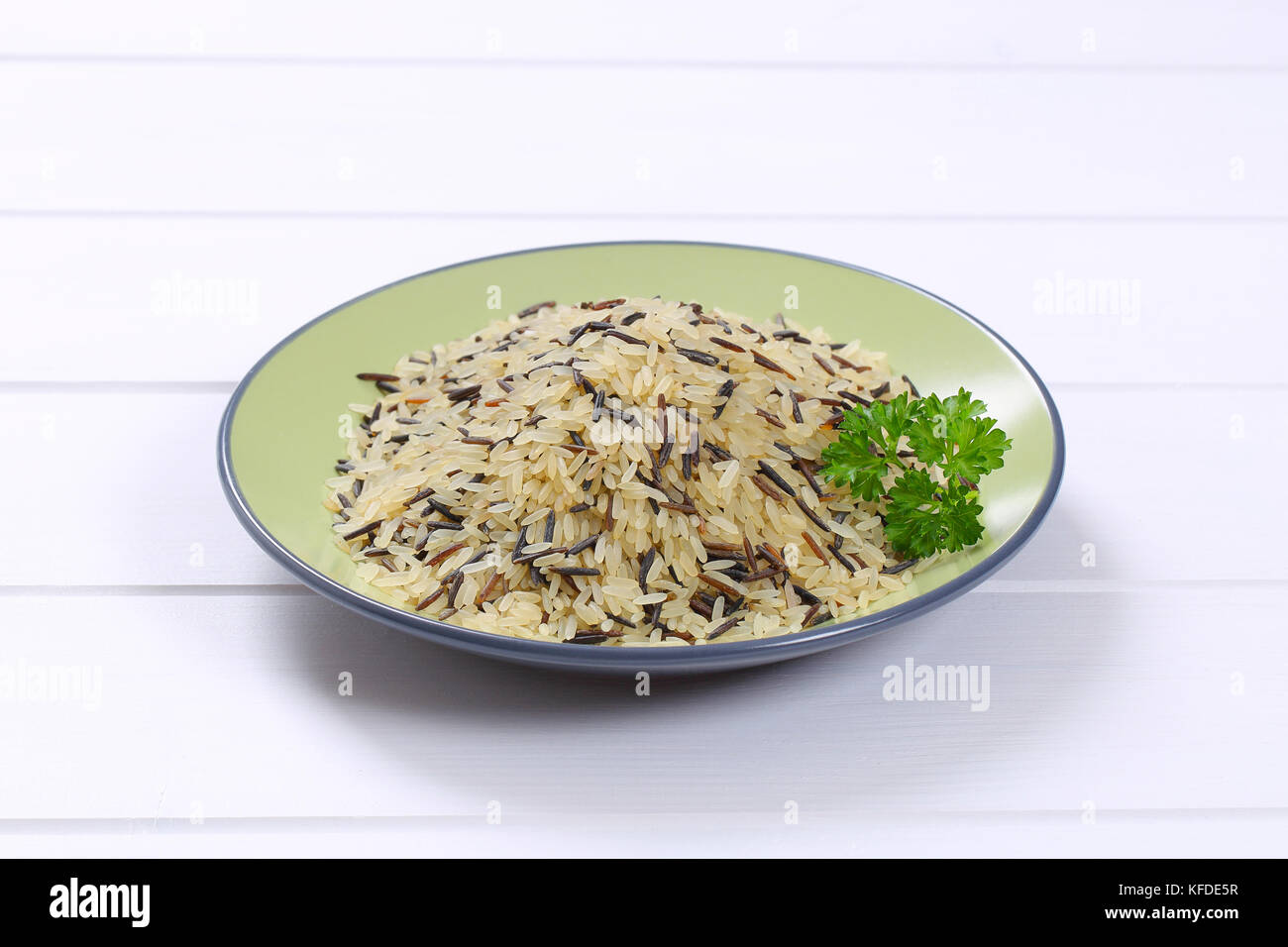 plate of wild rice on white wooden background Stock Photo - Alamy