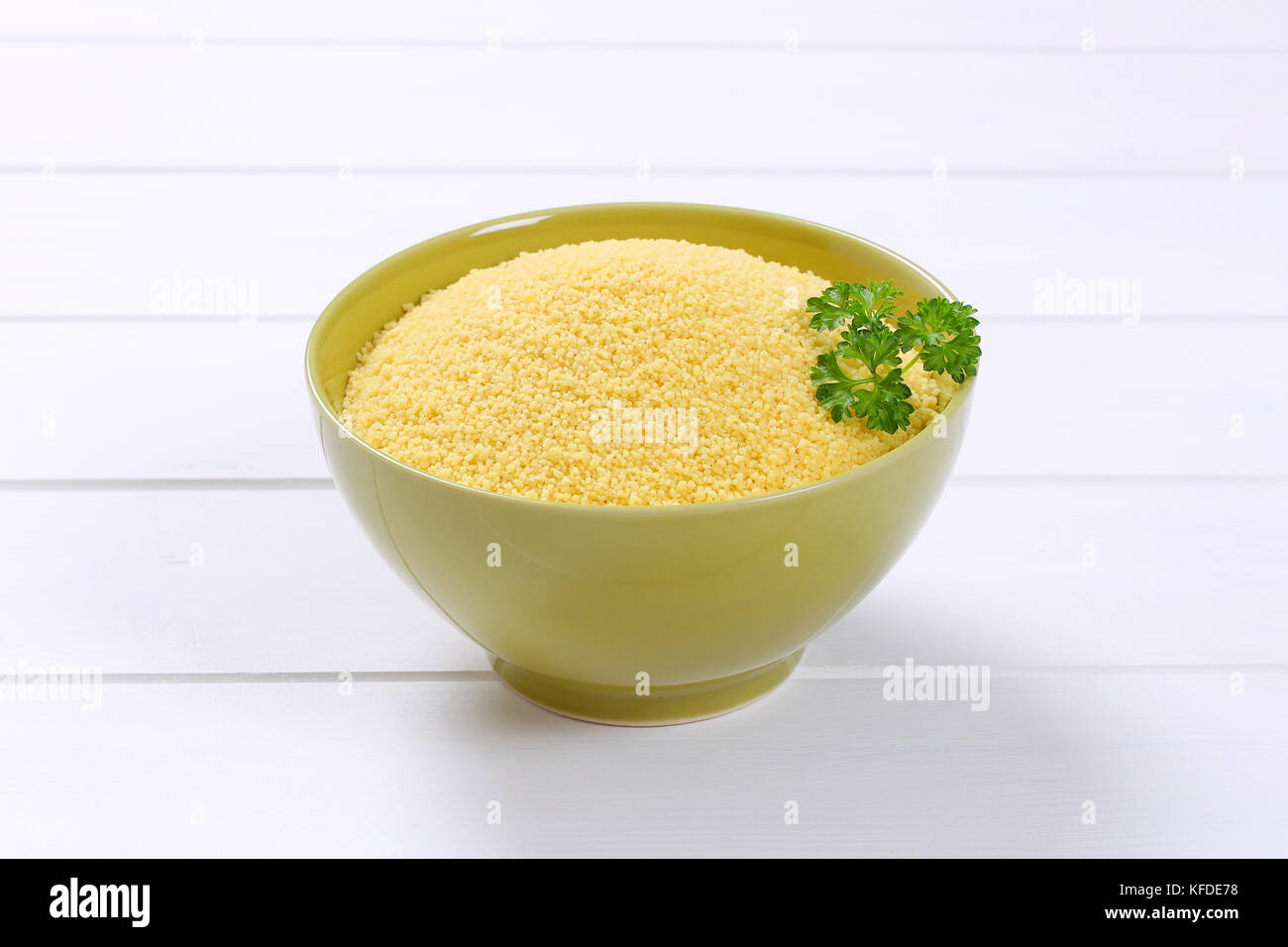 bowl of raw couscous on white wooden background Stock Photo - Alamy