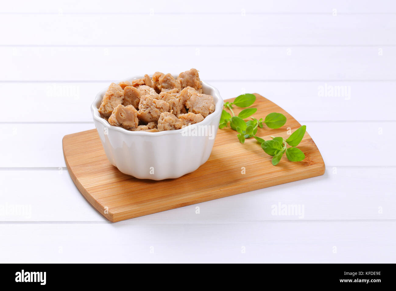 bowl of soy meat cubes on wooden cutting board Stock Photo - Alamy