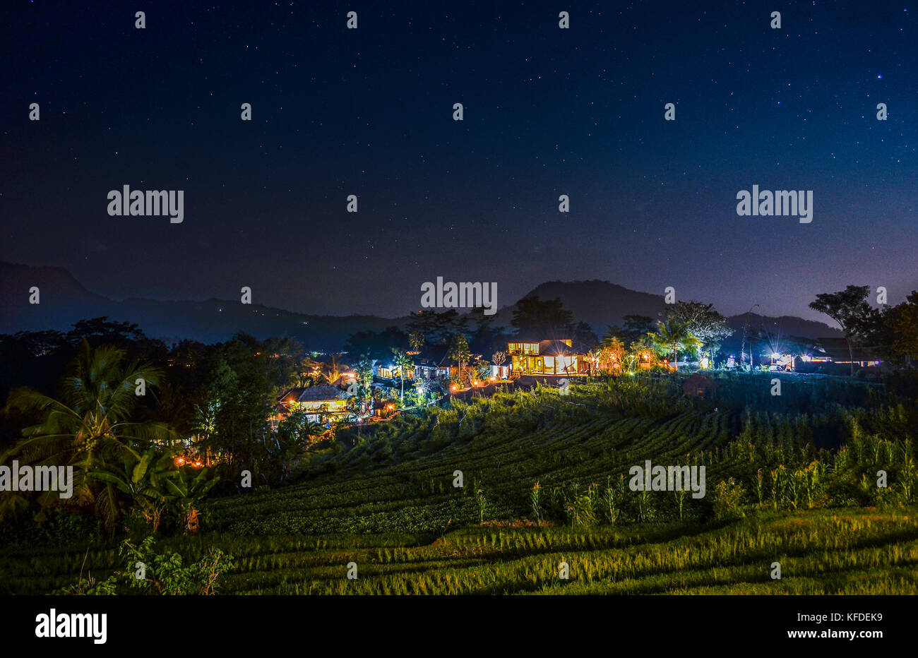 Night view of Bali Island, view across fields and hillside, to a ...