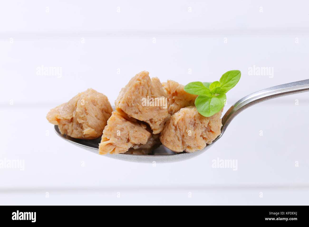 spoon of soy meat cubes on white wooden background Stock Photo - Alamy
